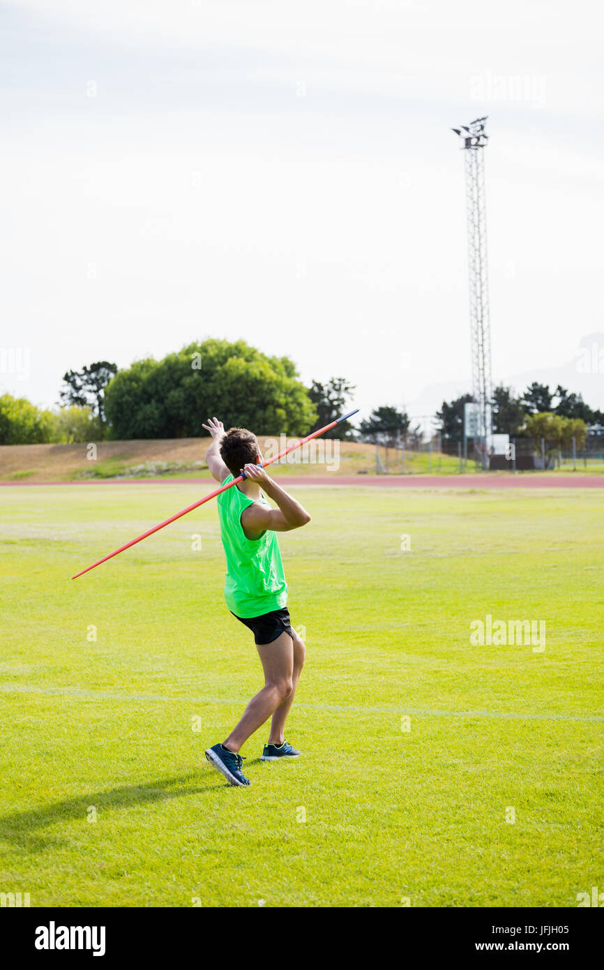 Rear view of an athlete about to throw a javelin Stock Photo - Alamy