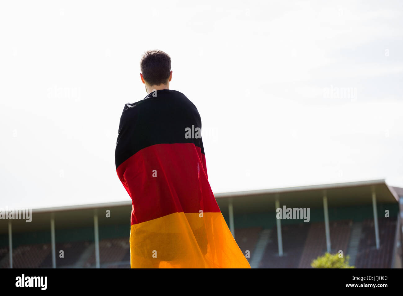 Athlete with german flag wrapped around his body Stock Photo - Alamy