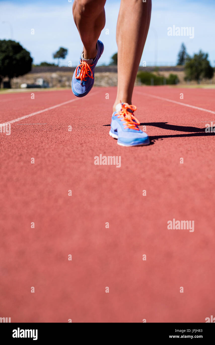 Female athlete feet running on the running track Stock Photo - Alamy