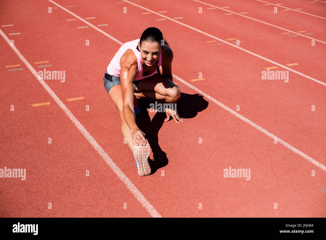 Portrait of female athlete stretching her hamstring Stock Photo - Alamy