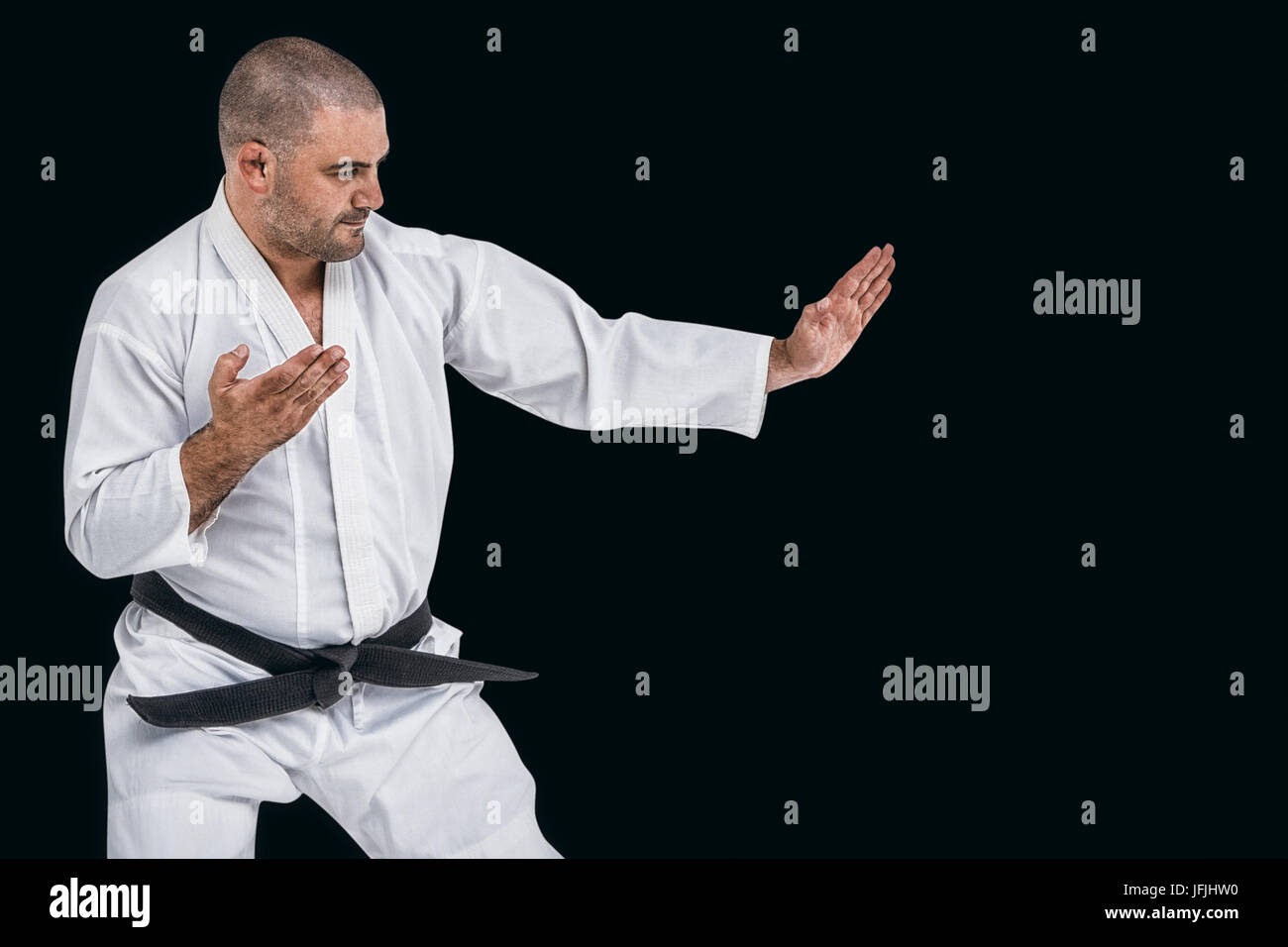 Composite image of fighter performing karate stance Stock Photo - Alamy