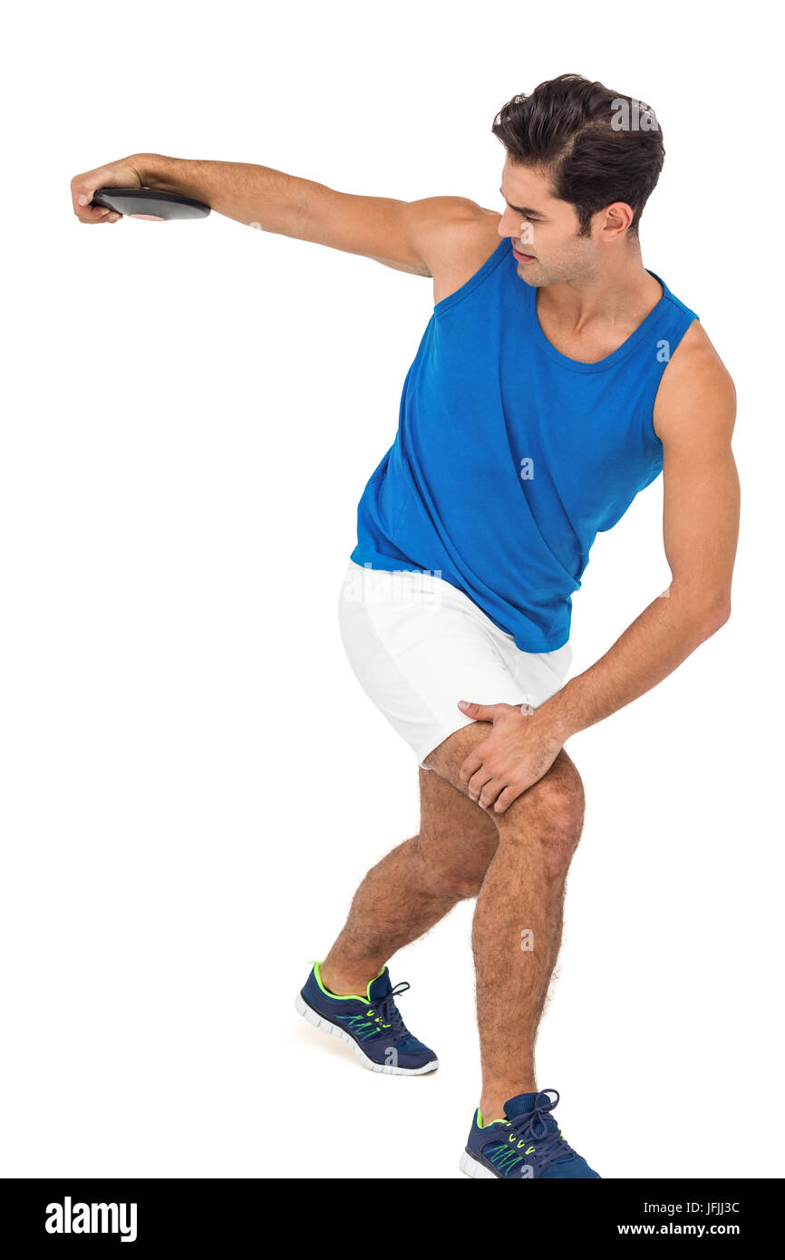 Male athlete playing discus throw on white background Stock Photo - Alamy