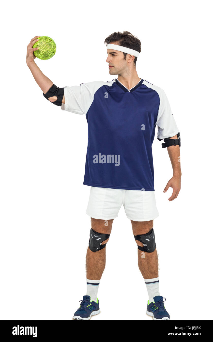 Sportsman posing with ball on white background Stock Photo - Alamy