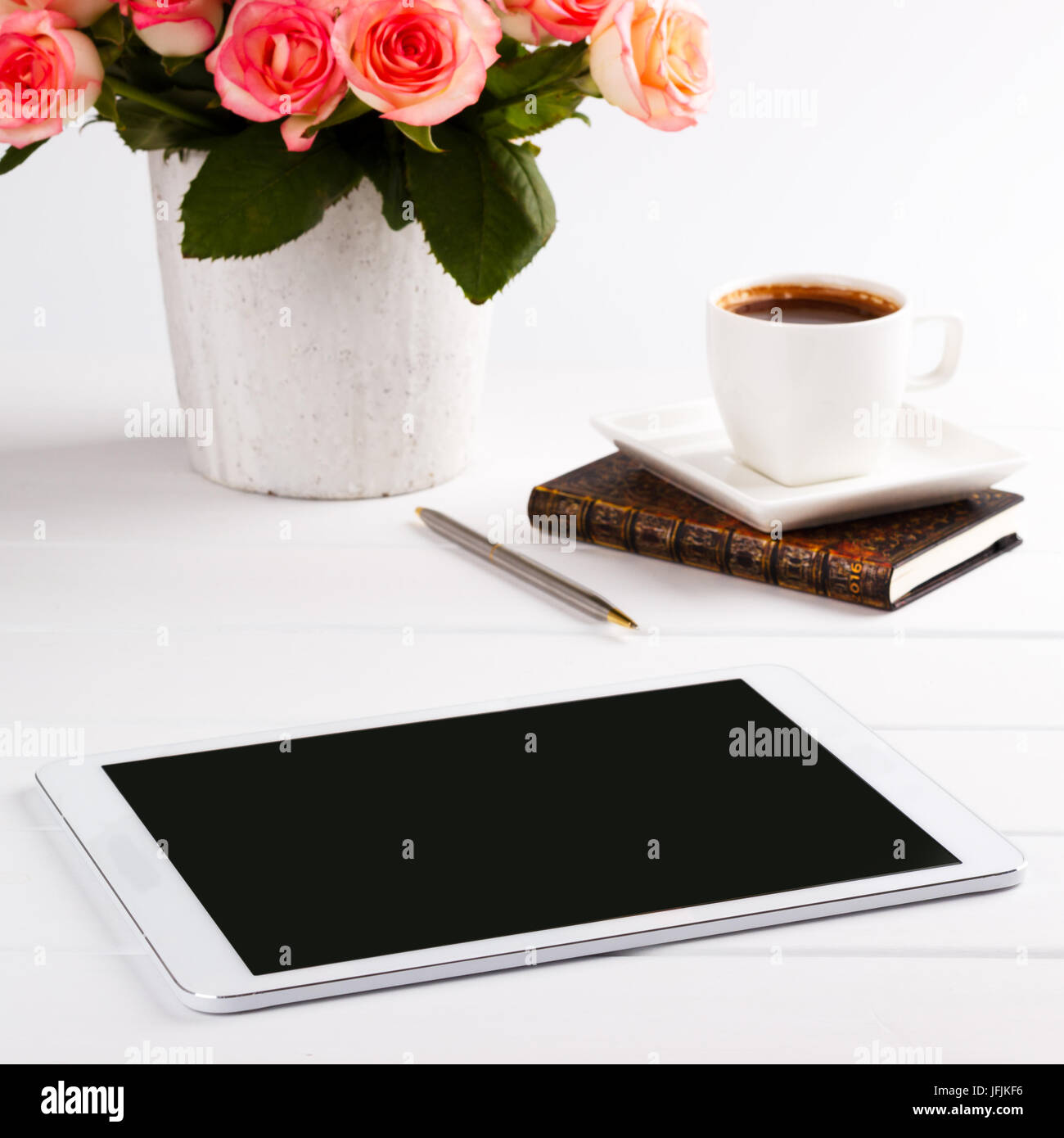 pink roses,notepad and tablet Stock Photo - Alamy