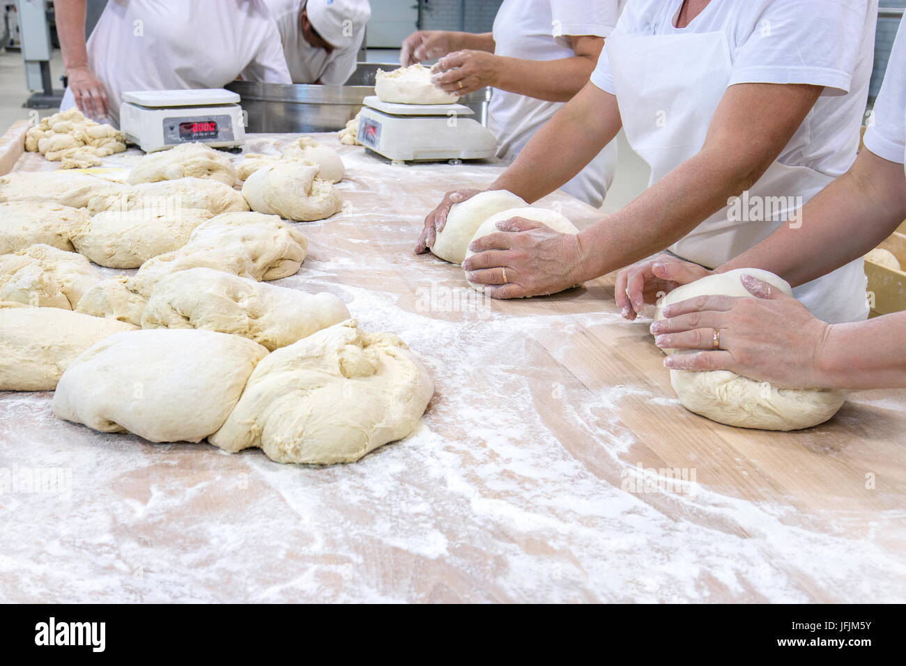 Bakery teamwork preparing weigh and dough for baking Stock Photo - Alamy