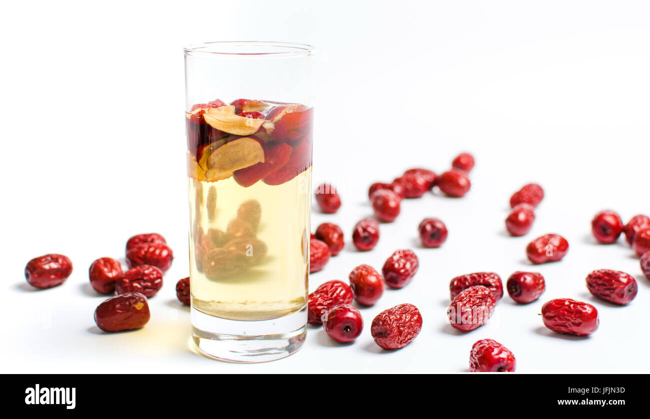 Chinese red dates fruit tea in a glass on white Stock Photo - Alamy