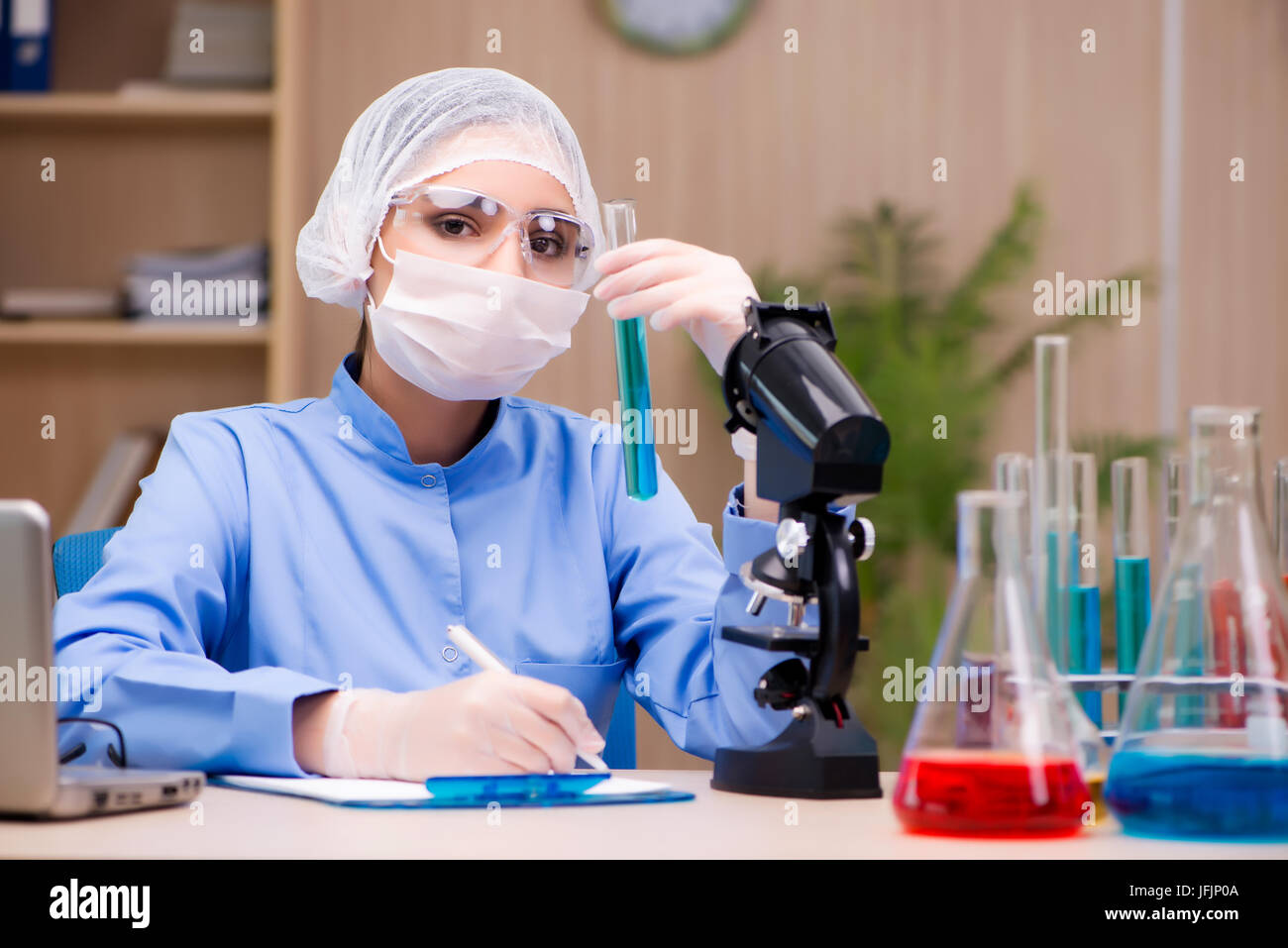 Lab chemist working with microscope and tubes Stock Photo - Alamy