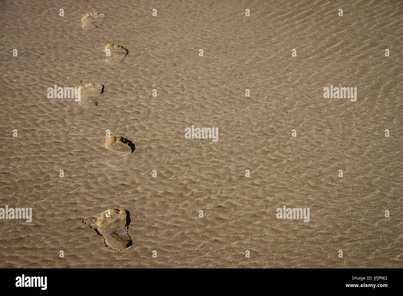 Footsteps in the sand Stock Photo - Alamy