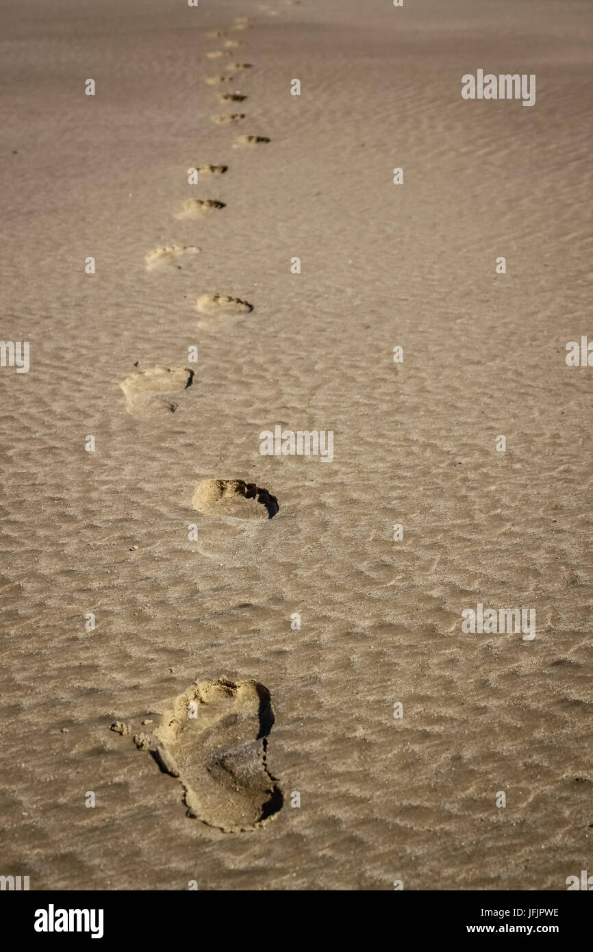 Footsteps in the sand Stock Photo - Alamy