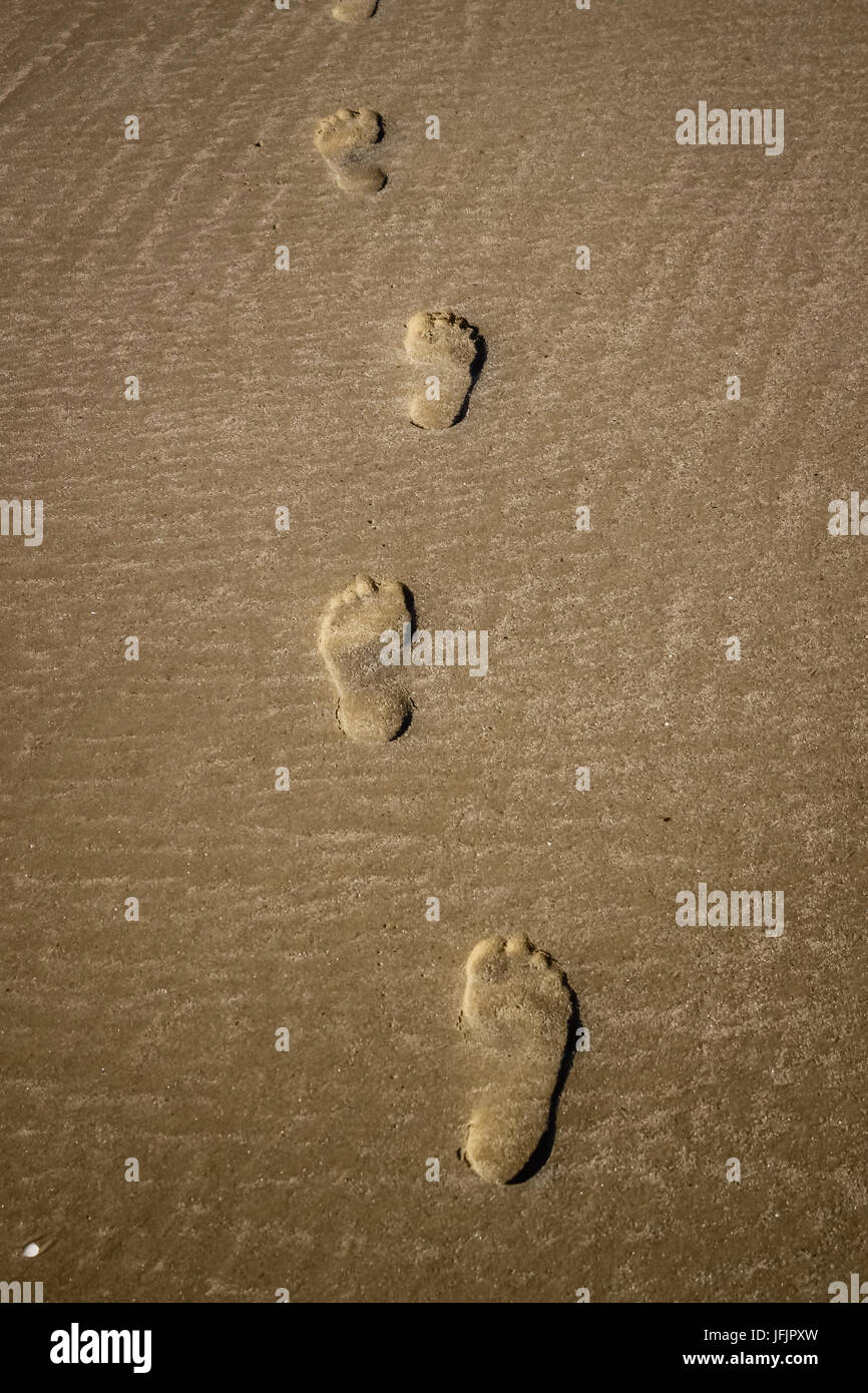 Footsteps in the sand Stock Photo - Alamy