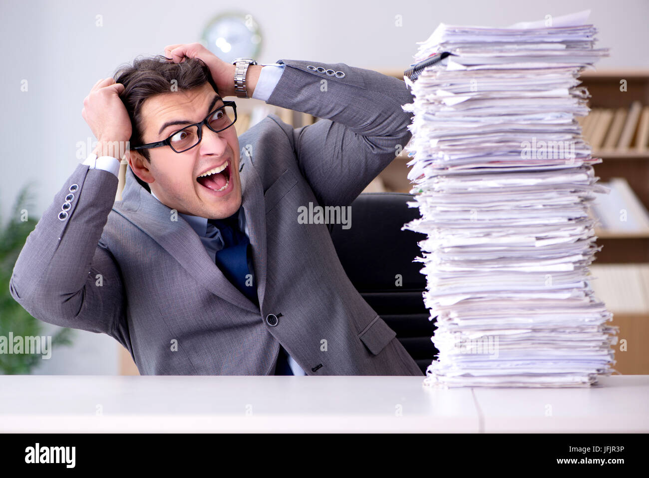 Businessman struggling to meet challenging deadlines Stock Photo - Alamy