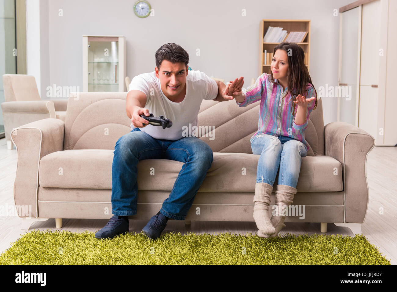 Young family suffering from computer games addiction Stock Photo - Alamy