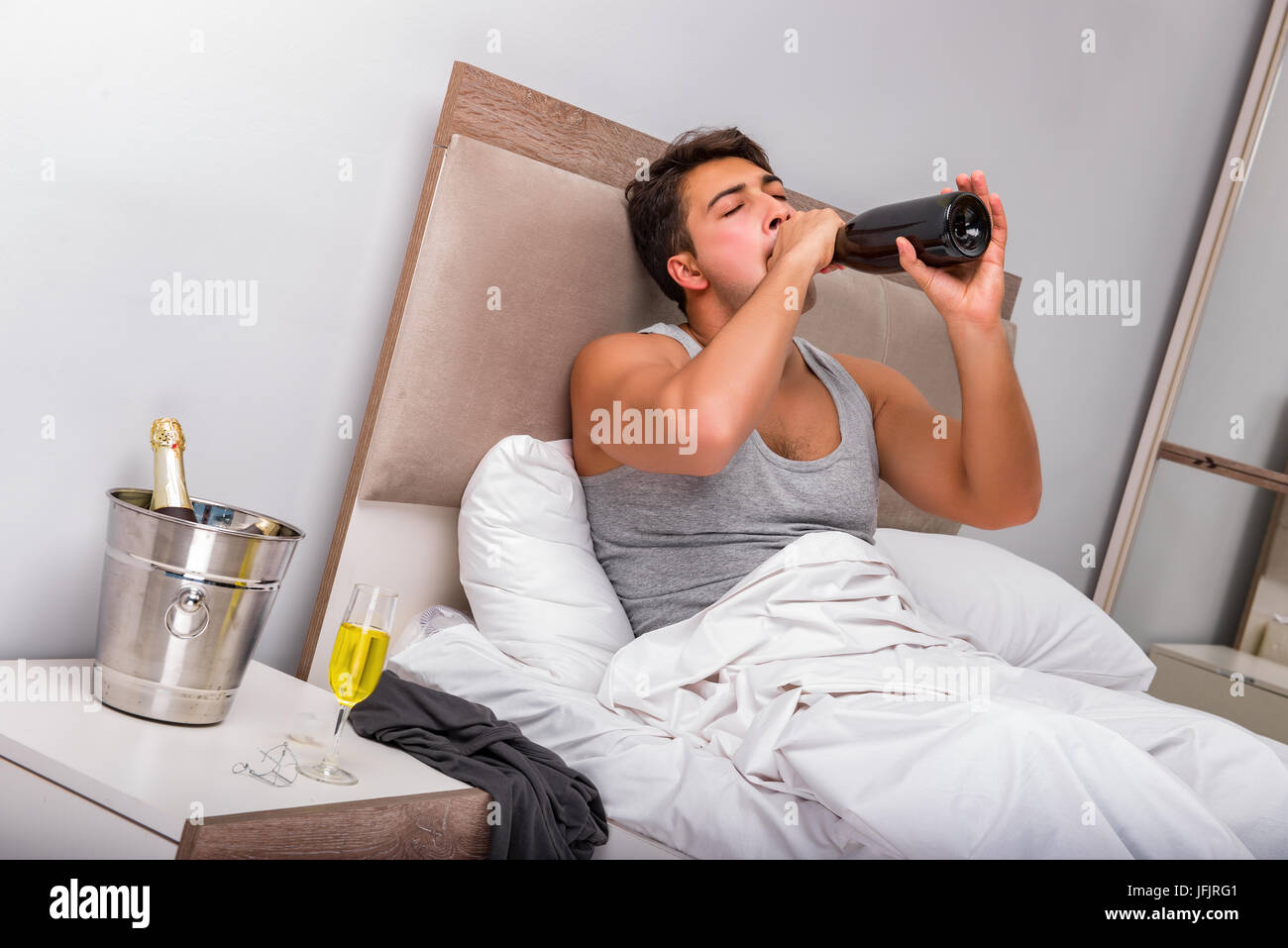 Man in the bed after party - Hangover concept Stock Photo - Alamy