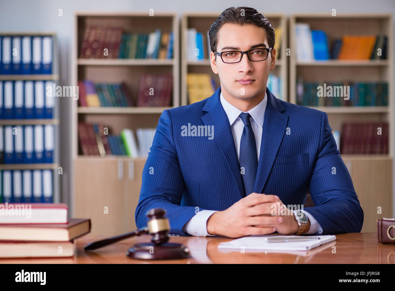 Handsome judge with gavel sitting in courtroom Stock Photo - Alamy