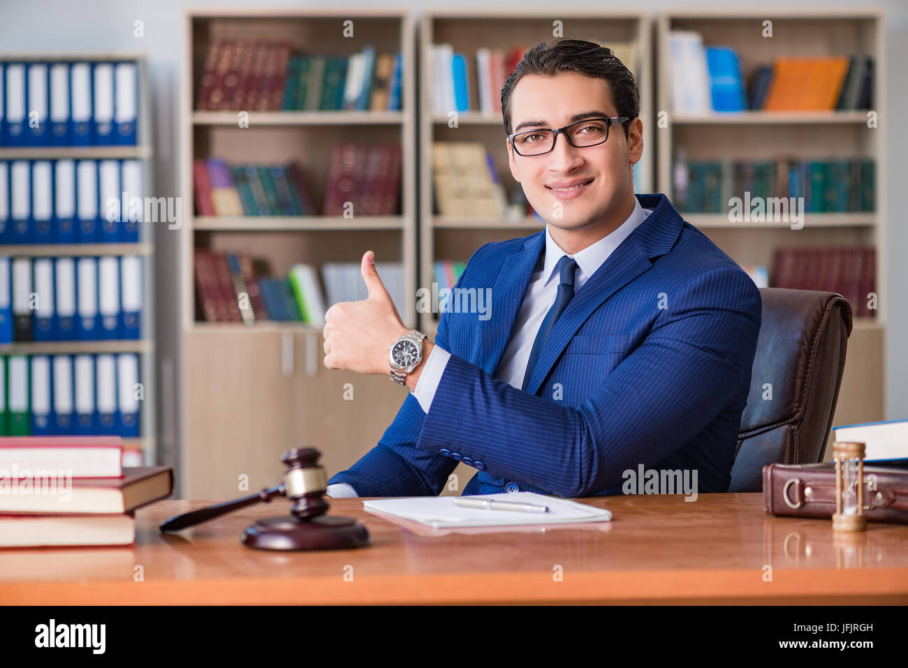 Handsome judge with gavel sitting in courtroom Stock Photo - Alamy