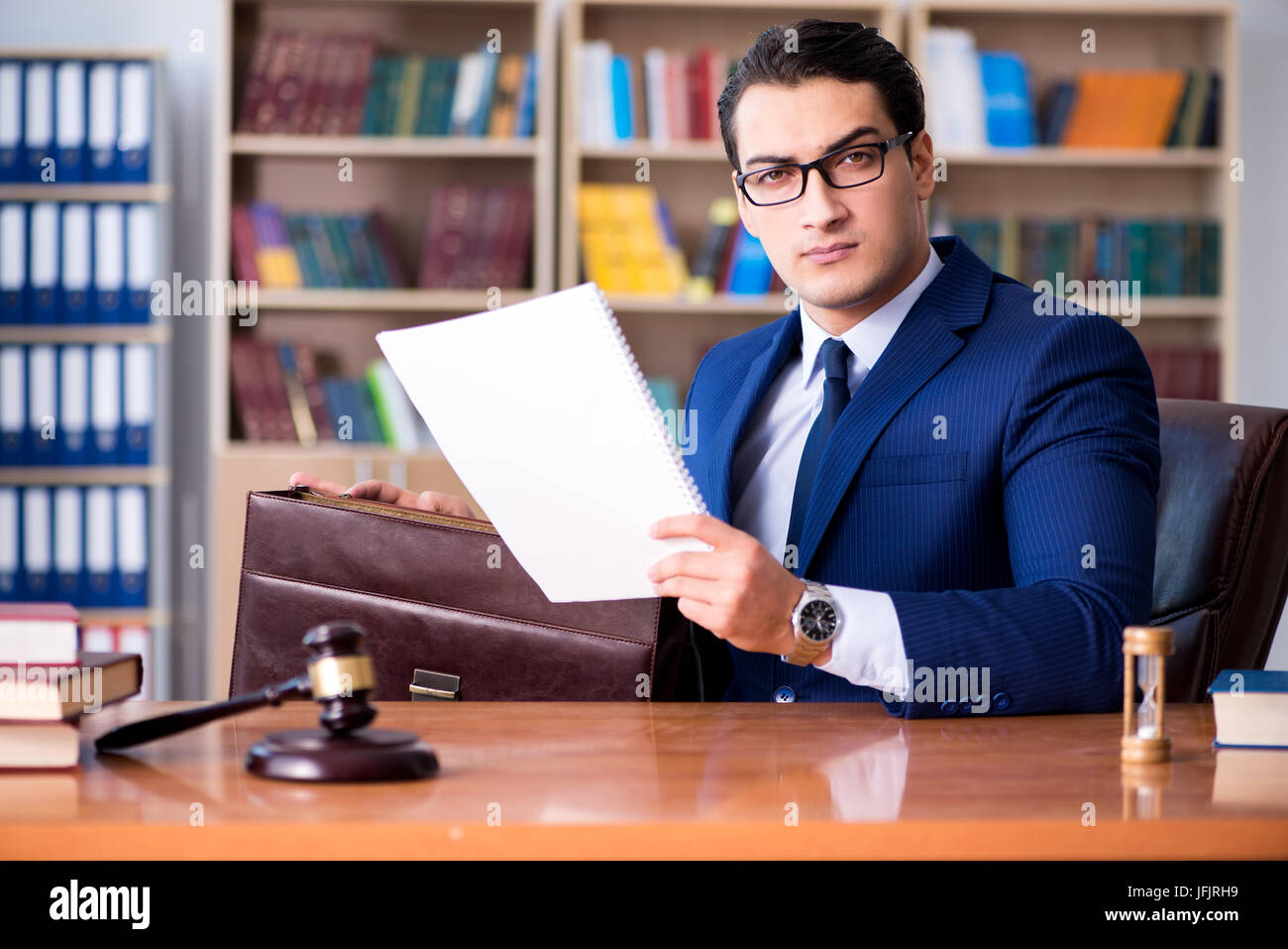 Handsome judge with gavel sitting in courtroom Stock Photo - Alamy