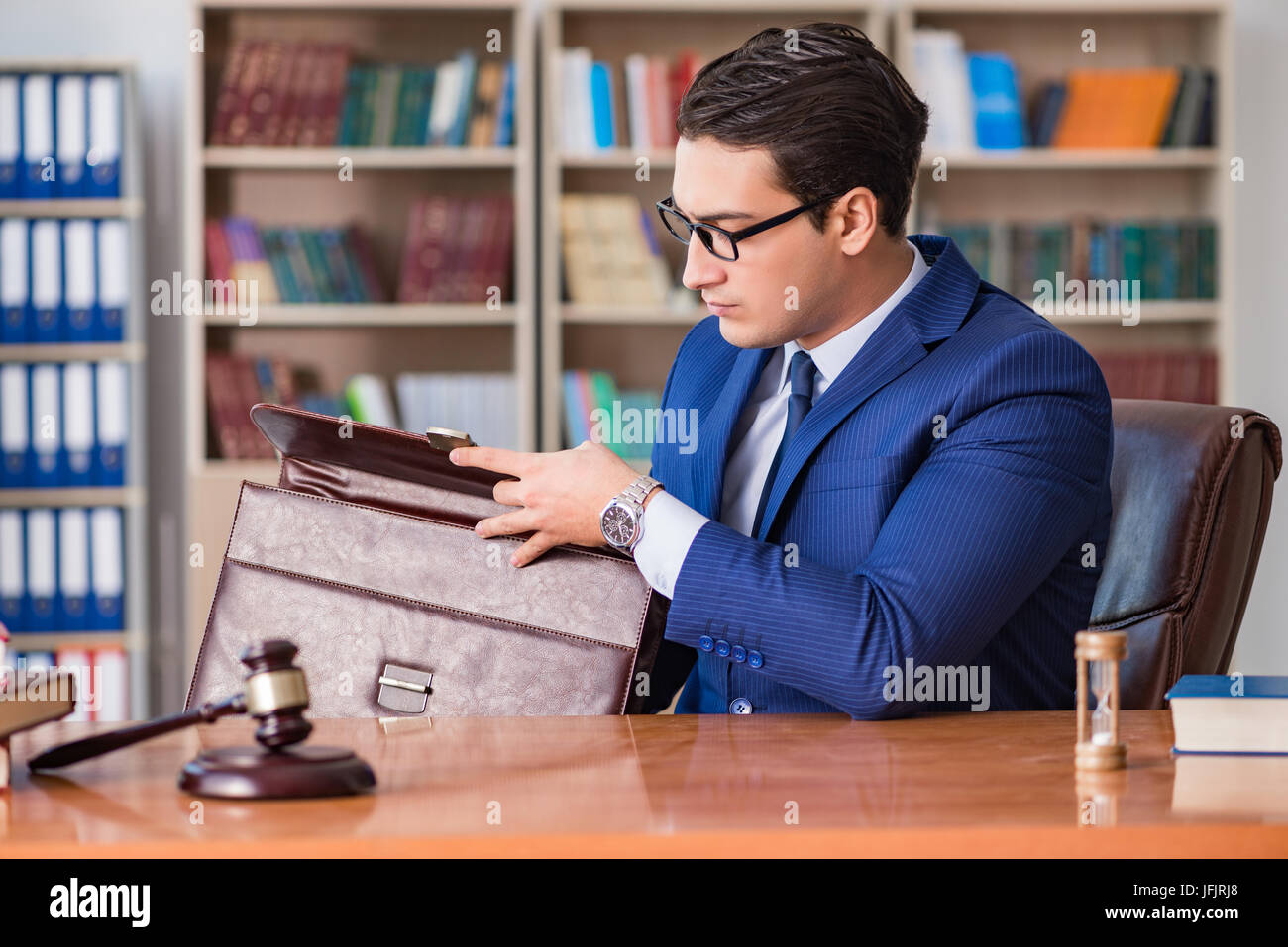 Handsome judge with gavel sitting in courtroom Stock Photo - Alamy