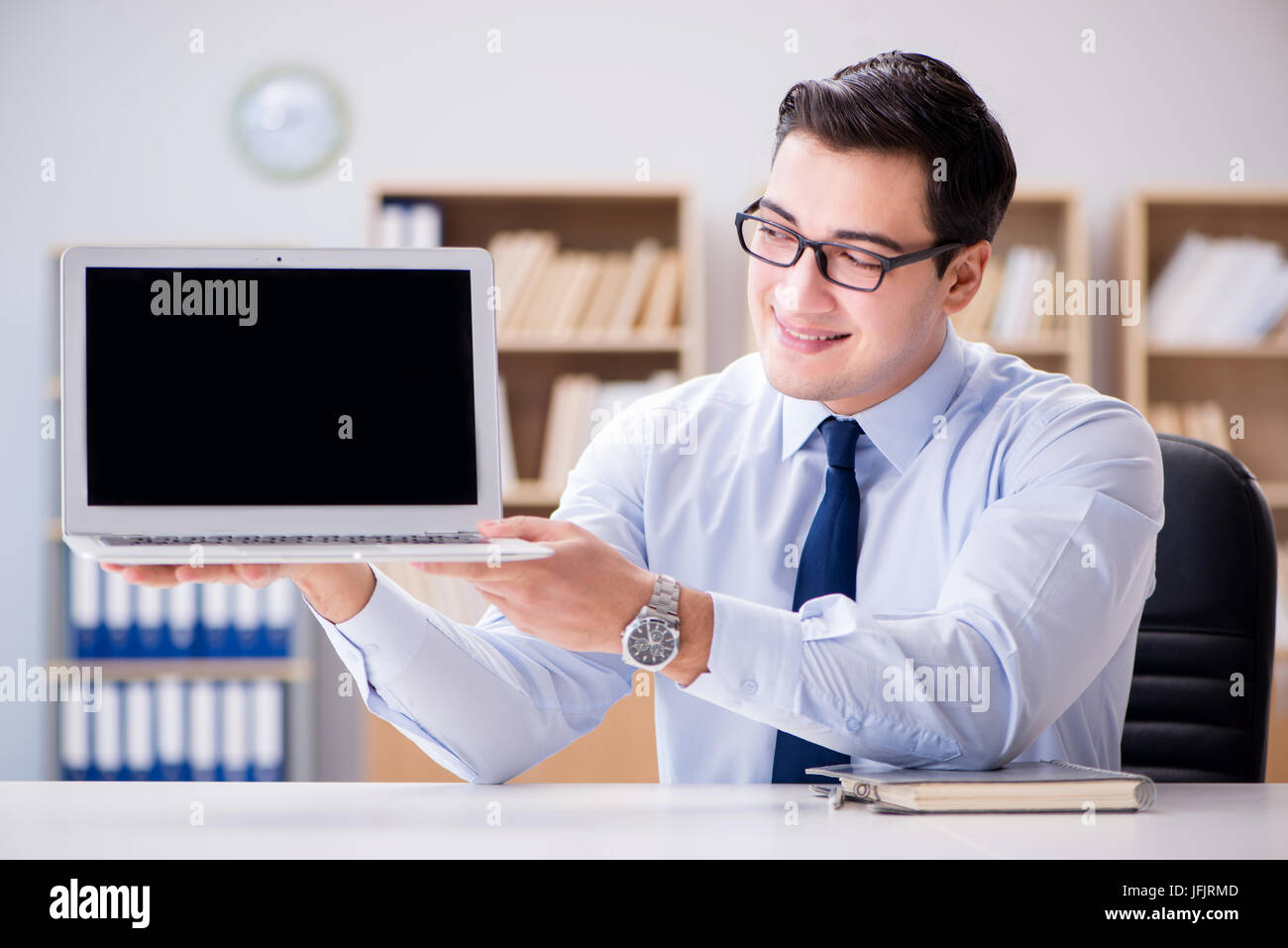 Businessman demonstrating the screen of laptop Stock Photo - Alamy