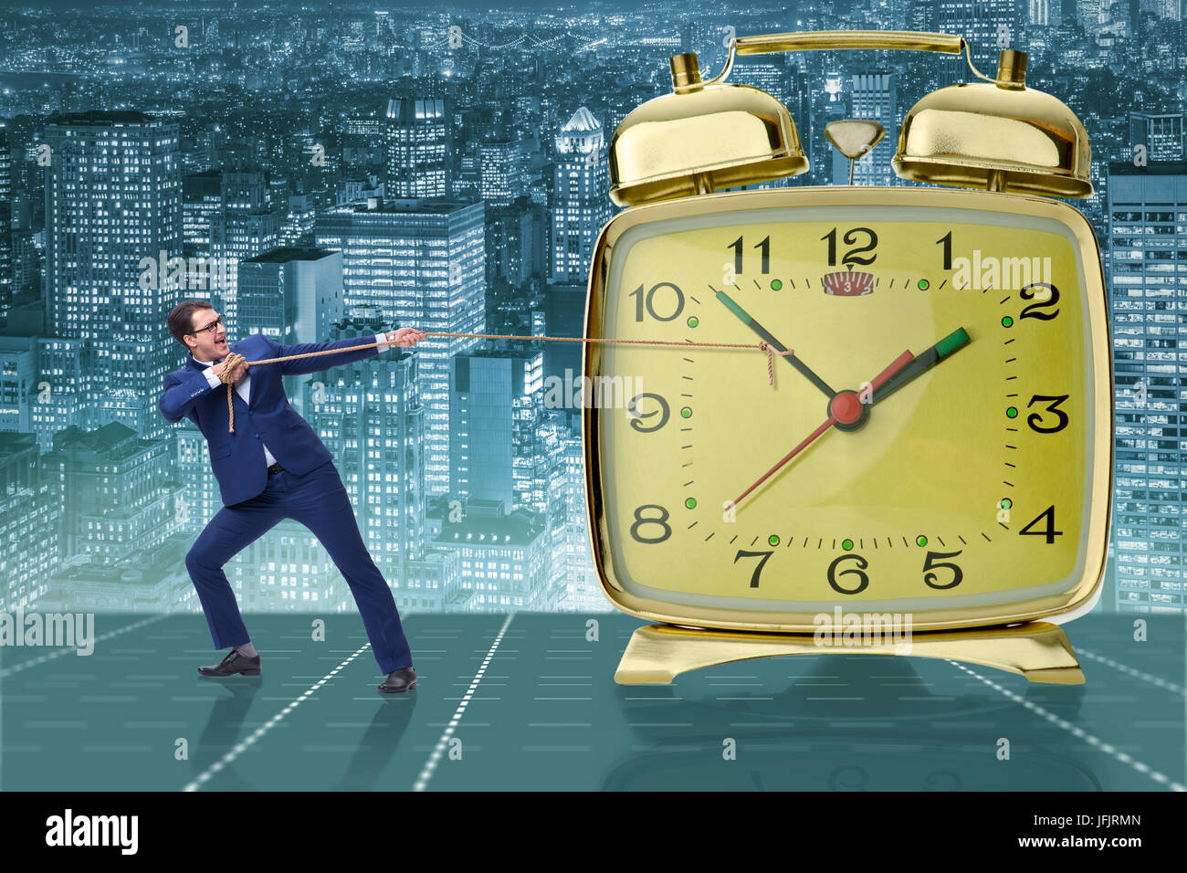 Businessman pulling clock in time management concept Stock Photo - Alamy