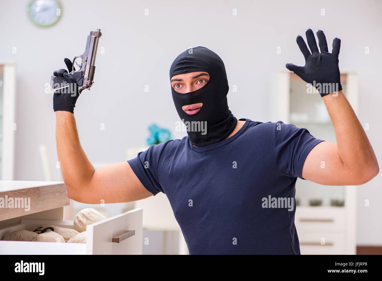 Robber wearing balaclava stealing valuable things Stock Photo - Alamy