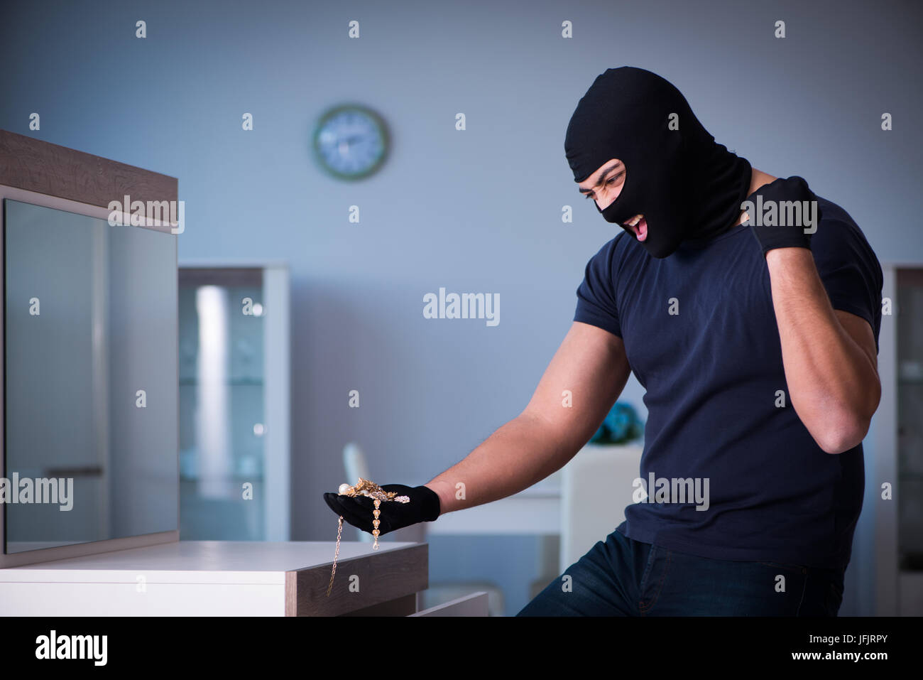 Robber wearing balaclava stealing valuable things Stock Photo - Alamy