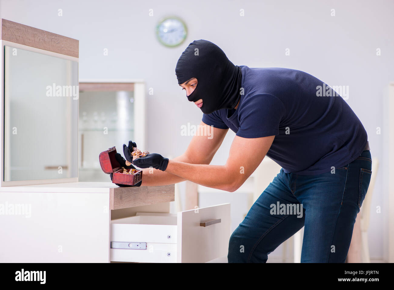 Robber wearing balaclava stealing valuable things Stock Photo - Alamy