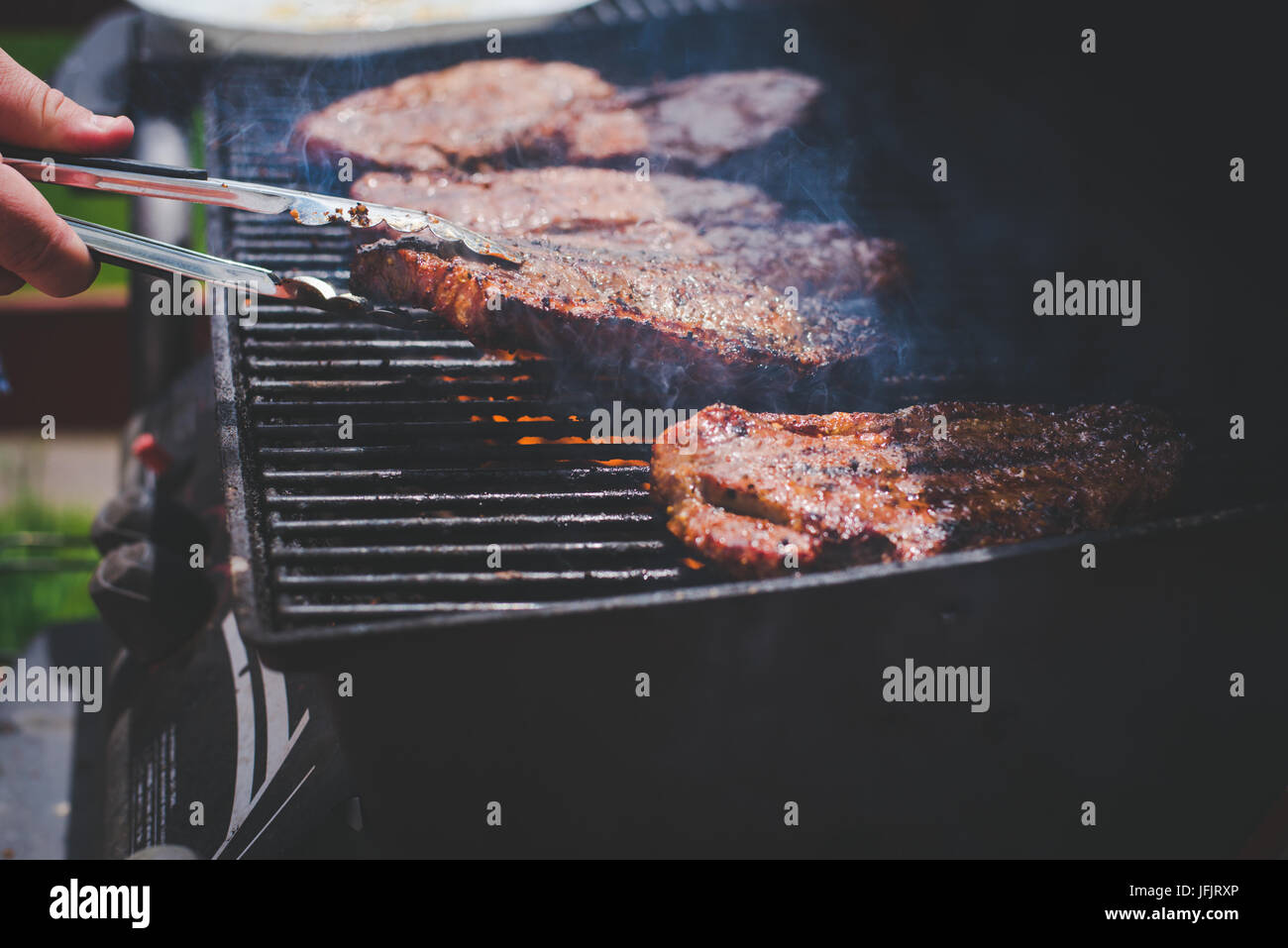 Steaks being cooked on grill Stock Photo - Alamy