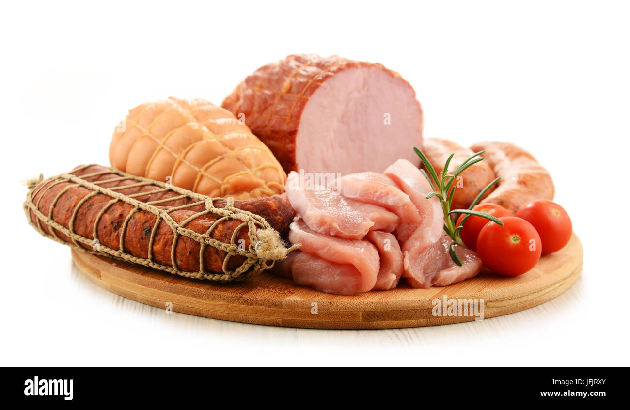 Assorted meat products including ham and sausages isolated on white ...
