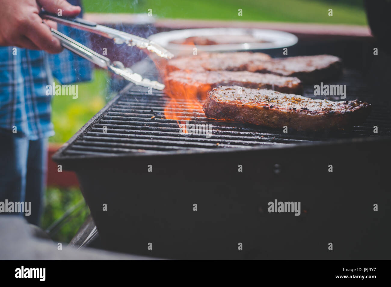 Steaks being cooked on grill Stock Photo - Alamy