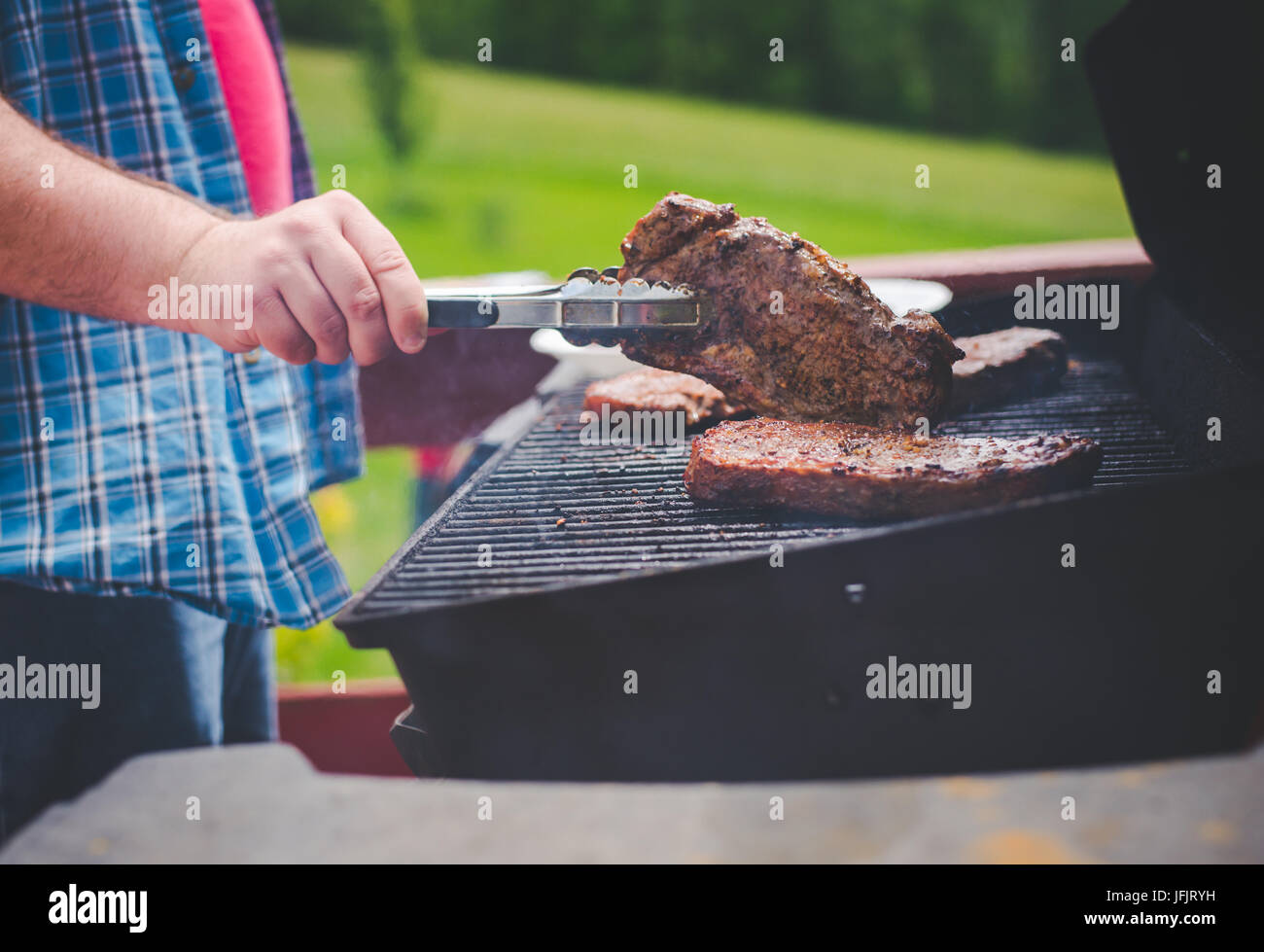 Steaks being cooked on grill Stock Photo - Alamy
