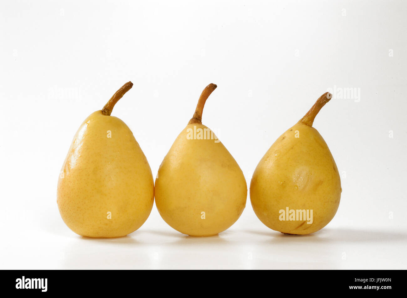 three yellow pears in a row with white background, fruit Stock Photo ...