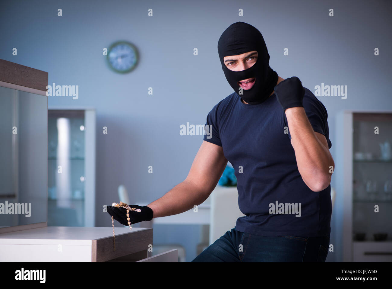 Robber wearing balaclava stealing valuable things Stock Photo - Alamy