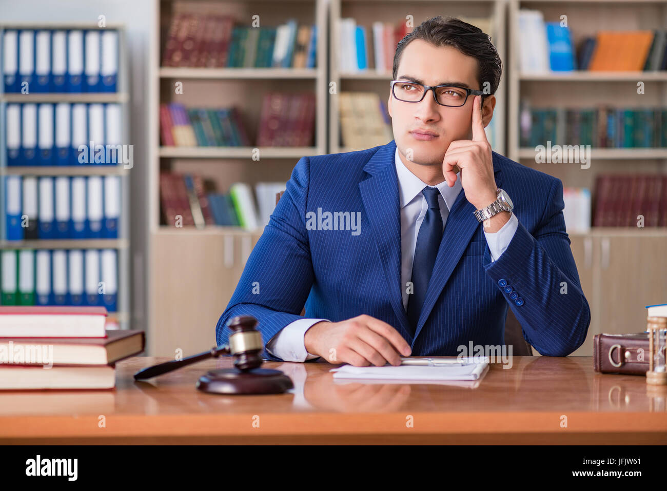 Handsome judge with gavel sitting in courtroom Stock Photo - Alamy