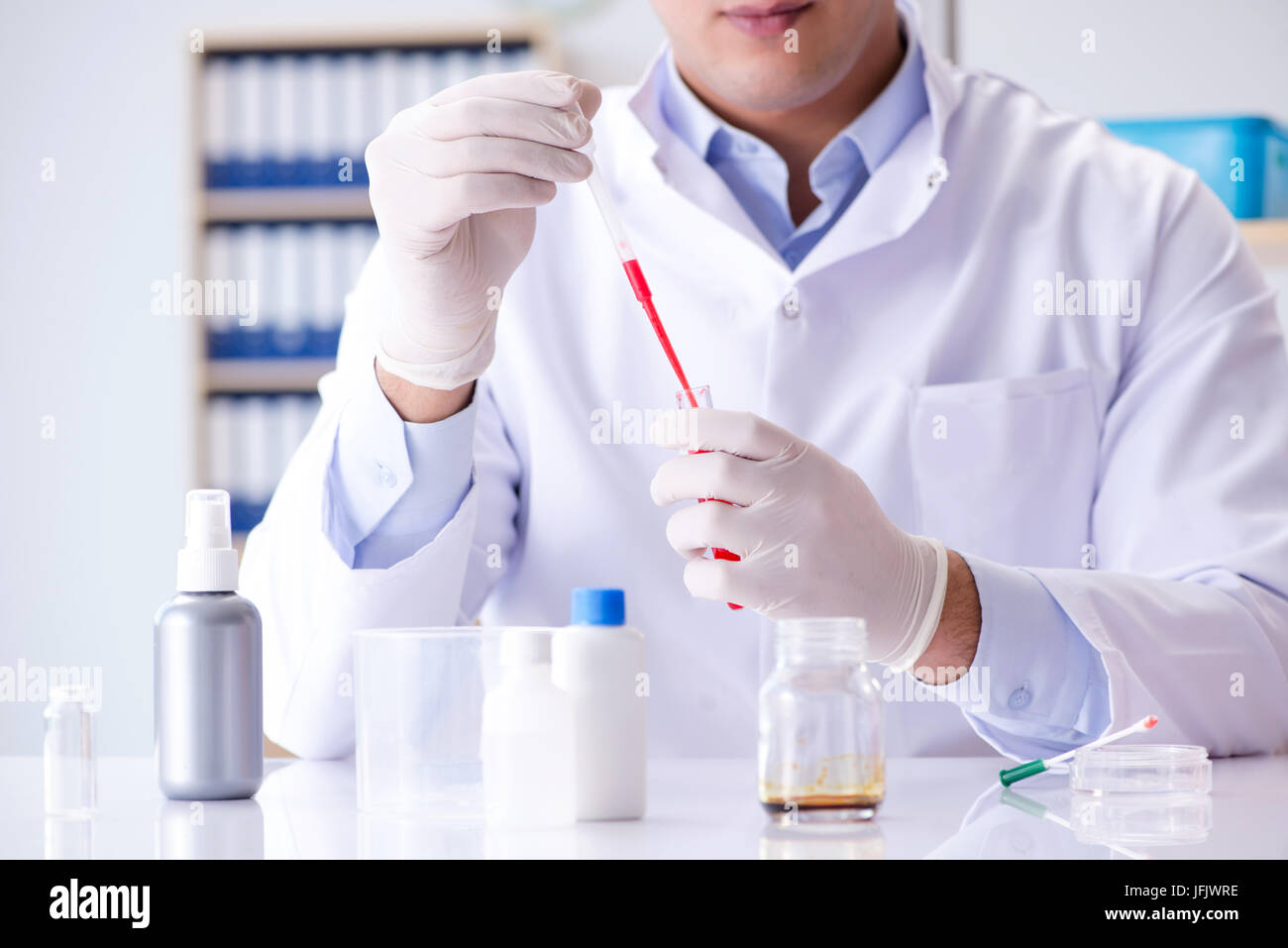 Blood testing in the lab with young scientist Stock Photo - Alamy