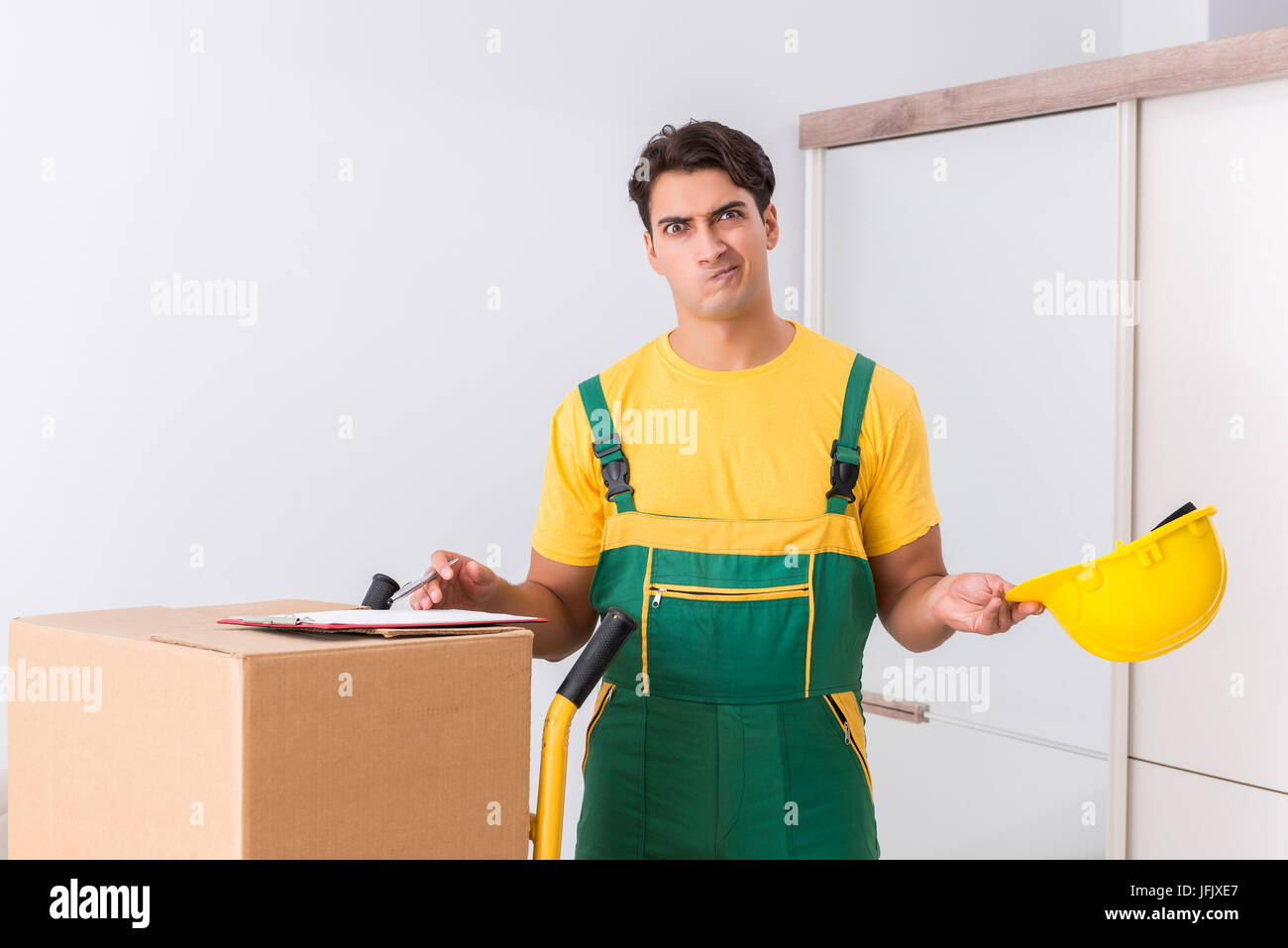 Transportation worker delivering boxes to house Stock Photo - Alamy