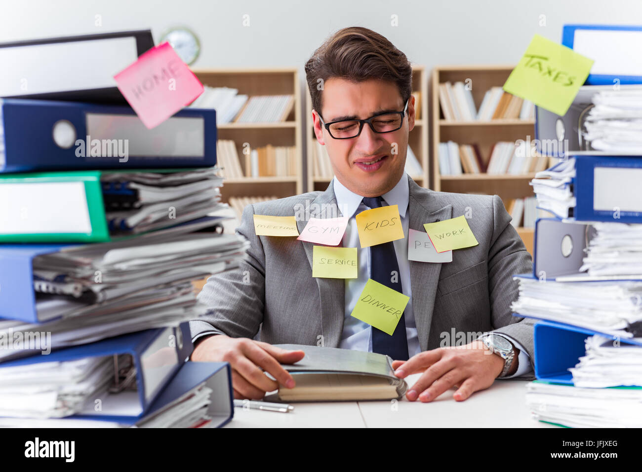 Businessman struggling with multiple priorities Stock Photo - Alamy