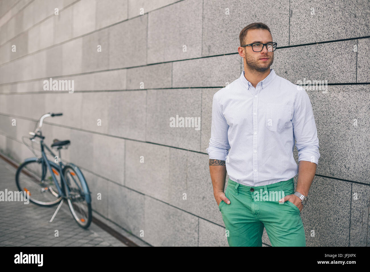 Cycling by the street. Full length of handsome young businessman with ...