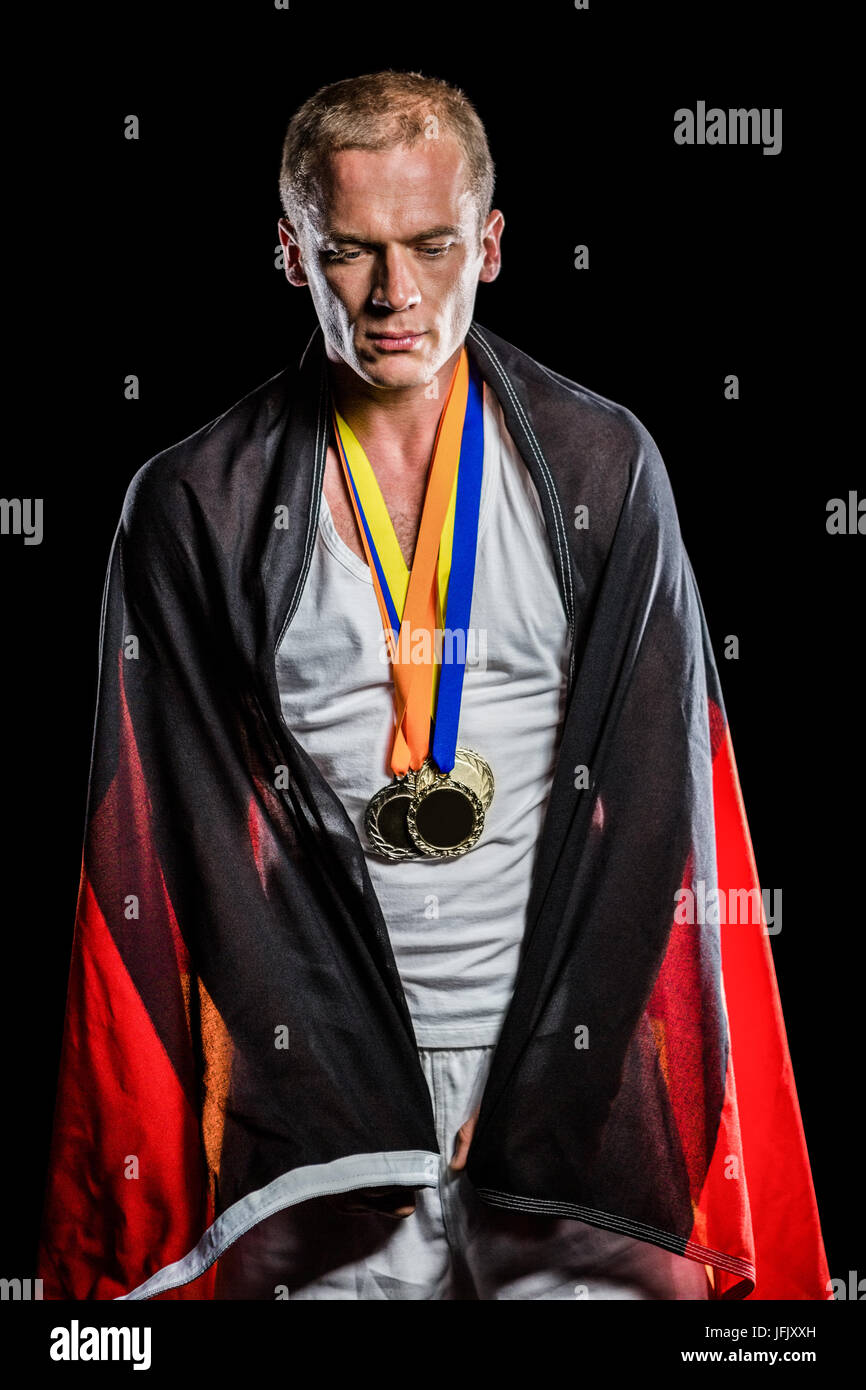 Athlete with german flag wrapped around his body Stock Photo - Alamy