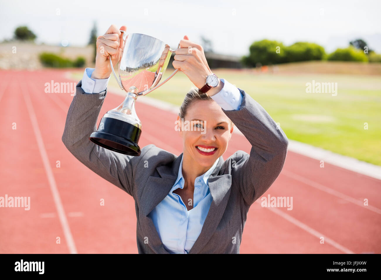Holding up a trophy hi-res stock photography and images - Alamy