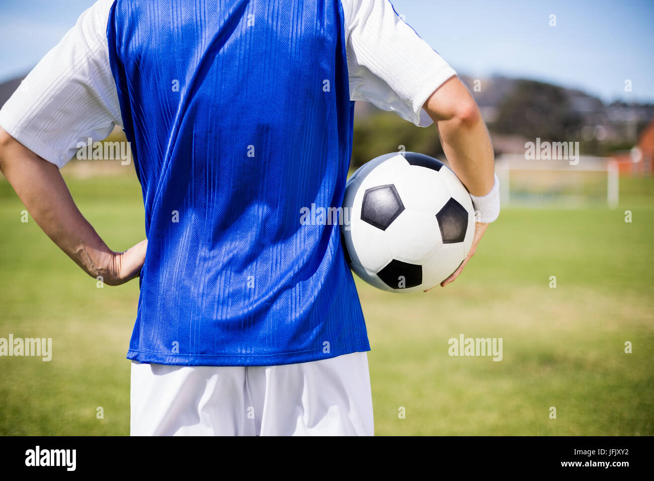 Football player ball under arm hi-res stock photography and images - Alamy
