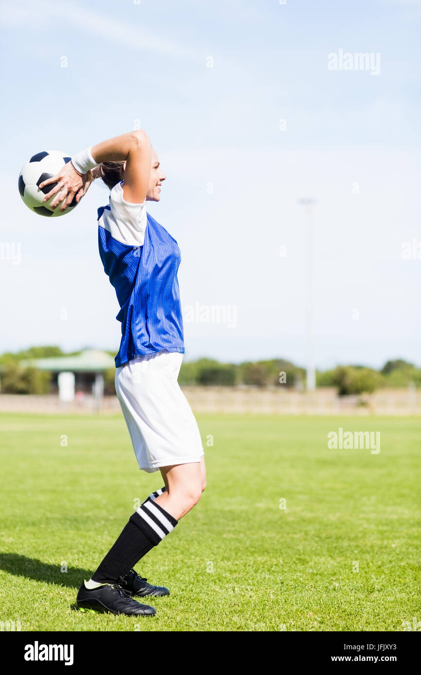 Female football player about to throw a football Stock Photo - Alamy