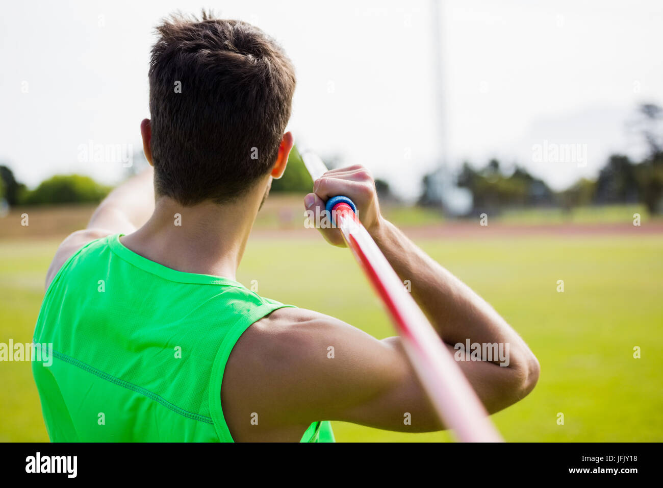 Rear view of an athlete about to throw a javelin Stock Photo - Alamy