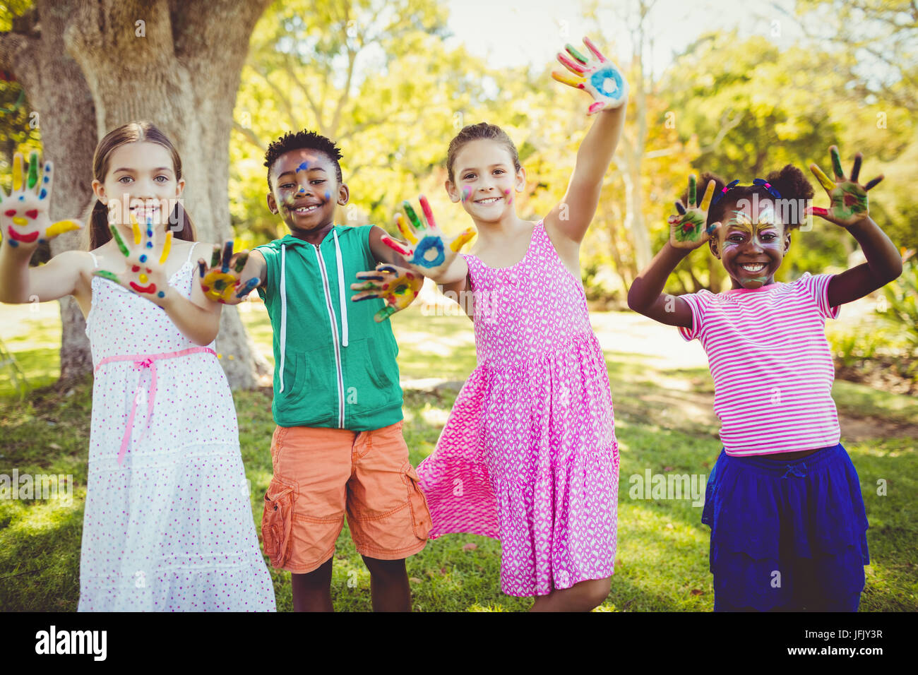 Portrait of cute children with make up having coloured hands Stock ...