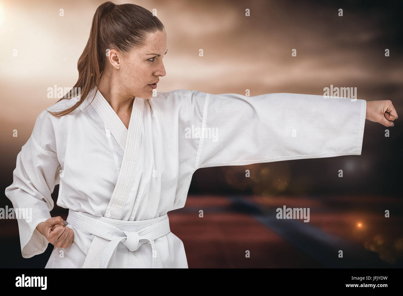 Composite image of fighter performing karate stance Stock Photo - Alamy