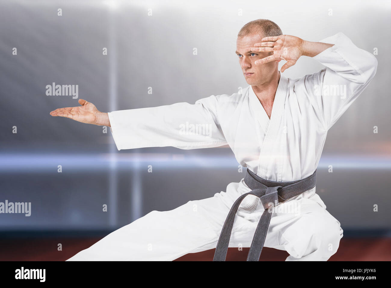 Composite image of fighter performing karate stance Stock Photo - Alamy