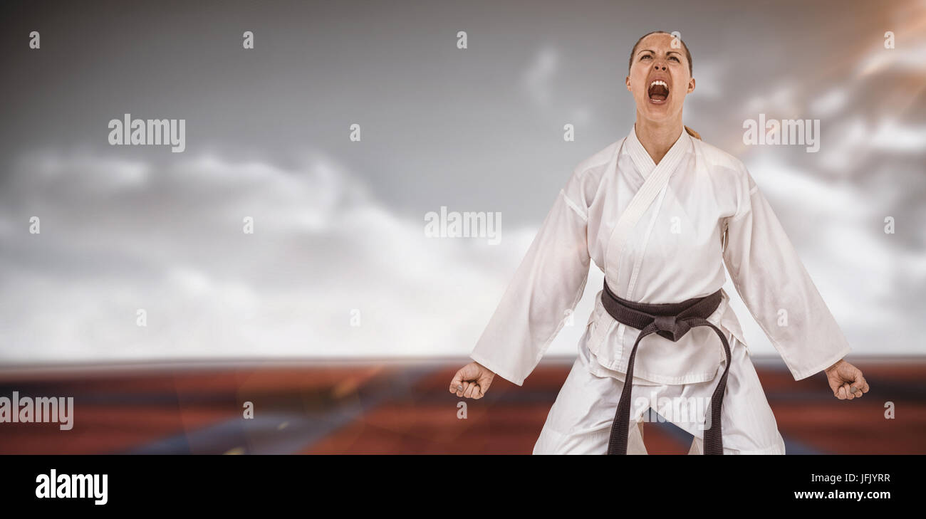 Composite image of female fighter posing after victory Stock Photo - Alamy