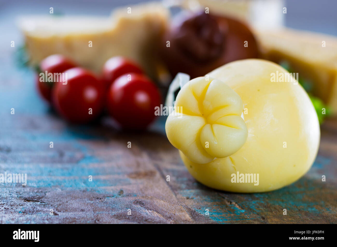 Traditional Italian hard cheese Provolone of Caciocavallo on wooden ... Traditional Italian hard cheese Provolone of Caciocavallo on wooden ...