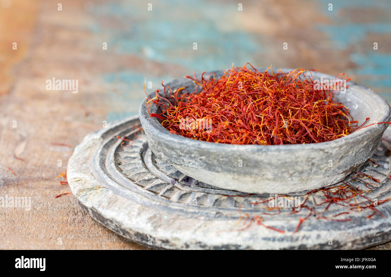 Dried organic red saffron Spice on wooden background with spoon Stock ...