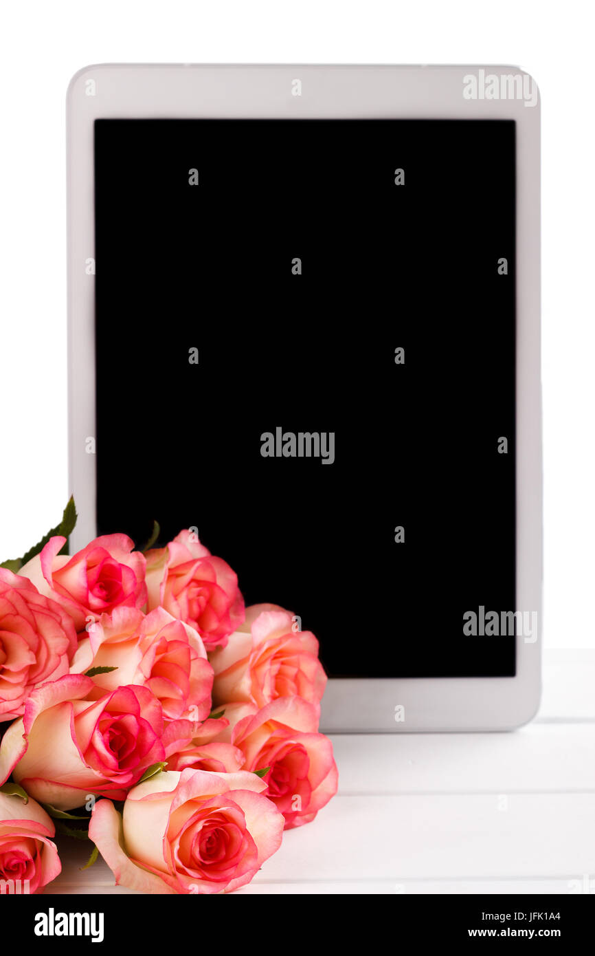 Tablet and pink roses Stock Photo - Alamy