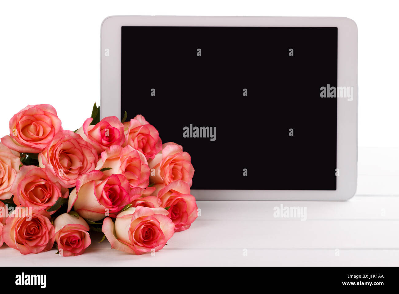 Tablet and pink roses Stock Photo - Alamy
